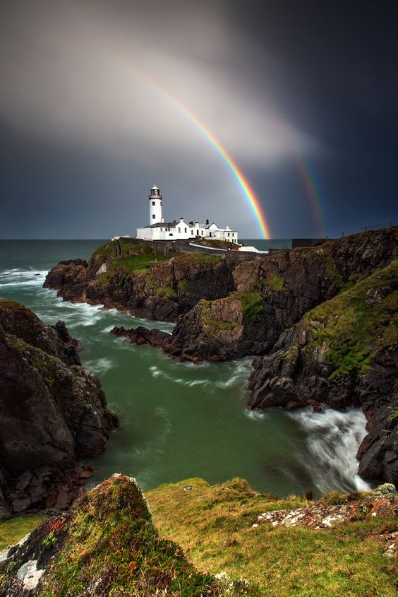 Double rainbow over a lighthouse
