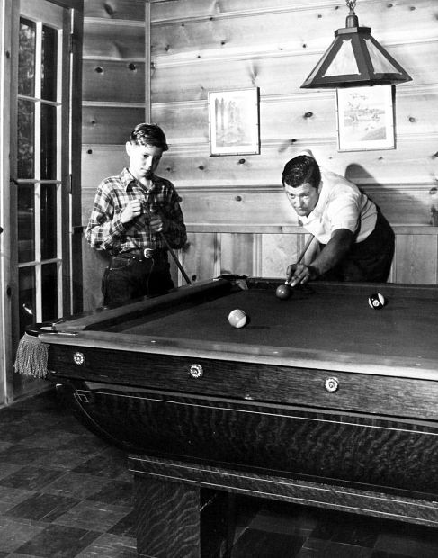 Dennis Morgan plays pool with his son Stanley